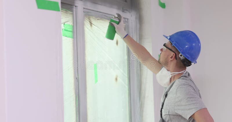 Construction Worker in Overalls Paints Wall White with Roller Stock ...