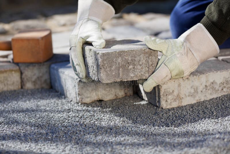 Construction Worker Paving the Brick Road Stock Photo - Image of ...