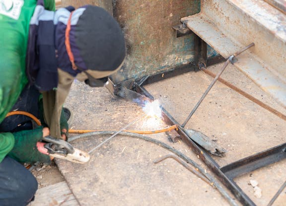 A Construction Worker Performing Manual Arc Welding on a Metal Frame ...