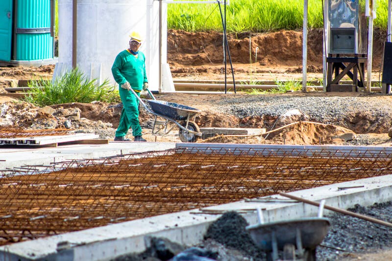 Construction Worker Performs the Construction of the Factory Shed ...