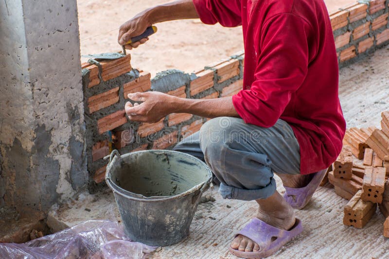 Construction Worker Placing Bricks on Cement for Building Exterior ...