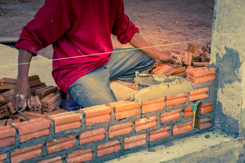 Construction Worker Placing Bricks on Cement for Building Exterior ...