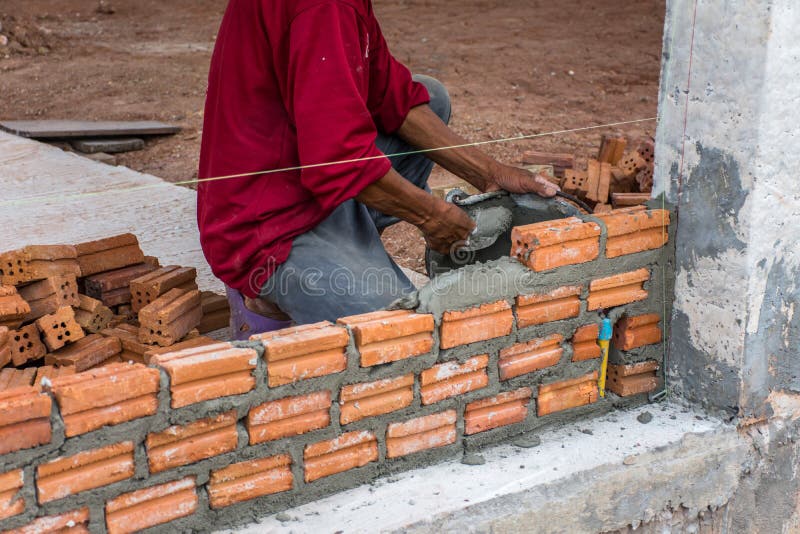 Construction Worker Placing Bricks on Cement for Building Exteri Stock ...
