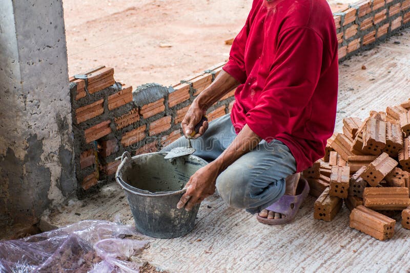 Construction Worker Placing Bricks on Cement for Building Exteri Stock ...