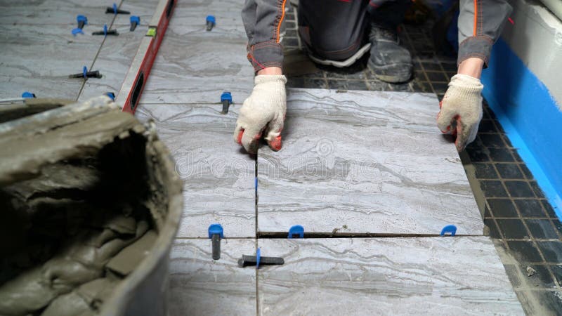 Construction Worker Placing Floor Tiles on Wet Cement Stock Image ...