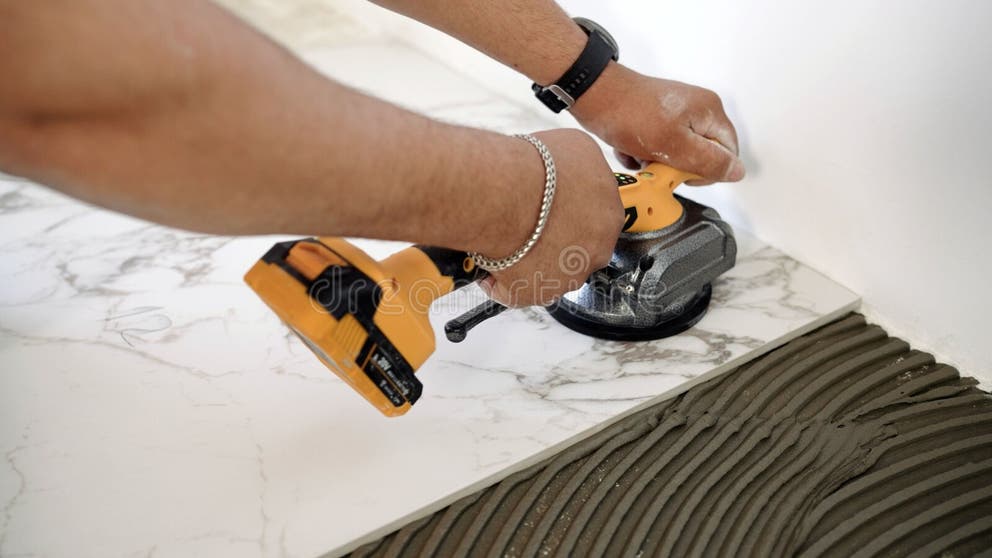 Construction Worker Placing Marble Tile Using Vibration Machine Stock ...