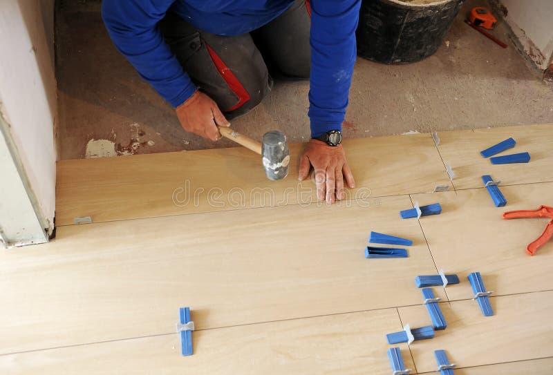 Construction Worker Placing a Porcelain Tile Floor Stock Photo - Image ...