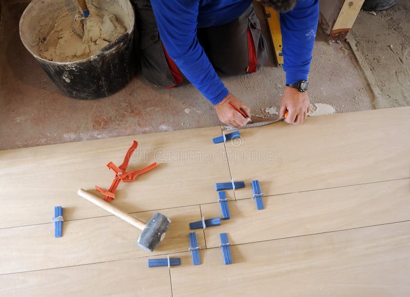 Construction Worker Placing a Porcelain Tile Floor Stock Photo - Image ...