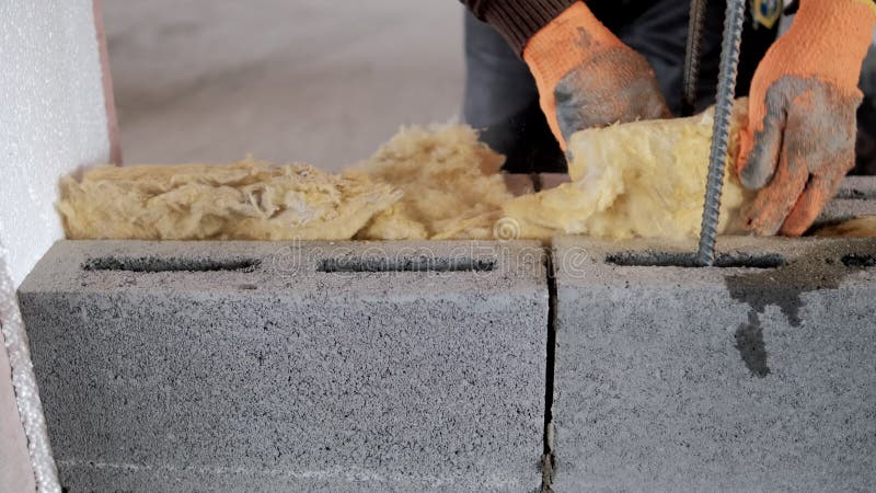 Construction Worker Placing Rock Wool Insulation between Concrete ...