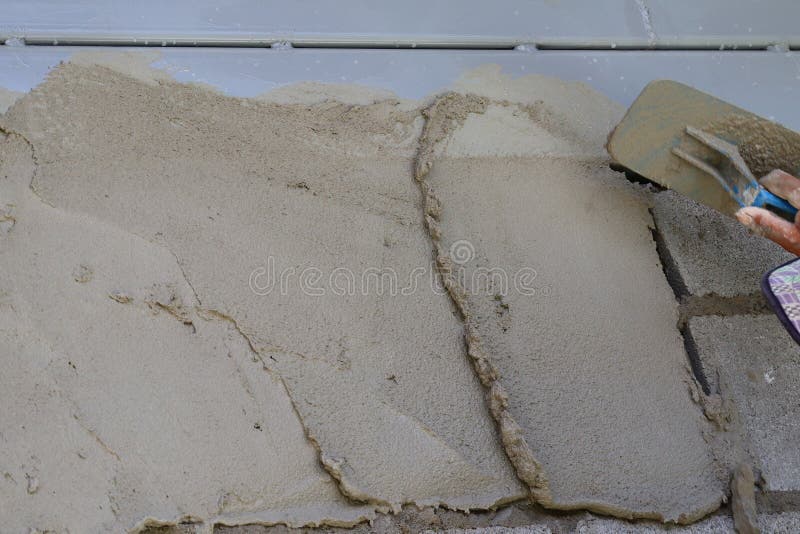 Construction Worker Plastering Cement on the Walls of the House ...