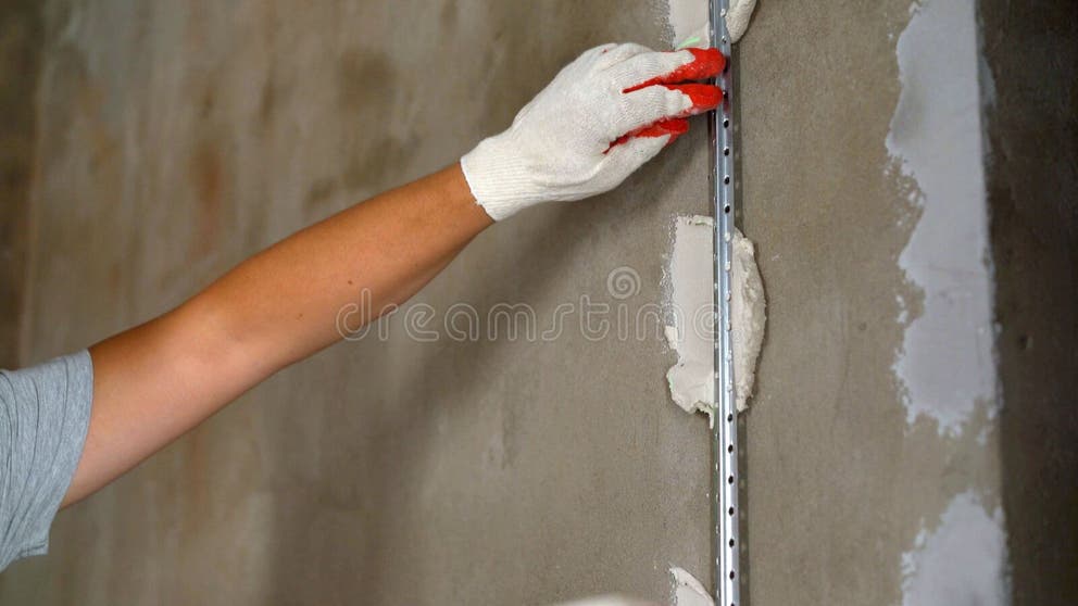 Construction Worker Installing Metal Profile on Wall Using Plaster and ...