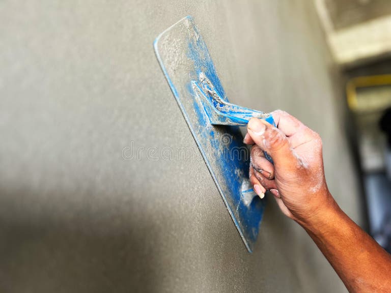 Construction Worker Plastering a Wall with a Blue Trowel Stock ...