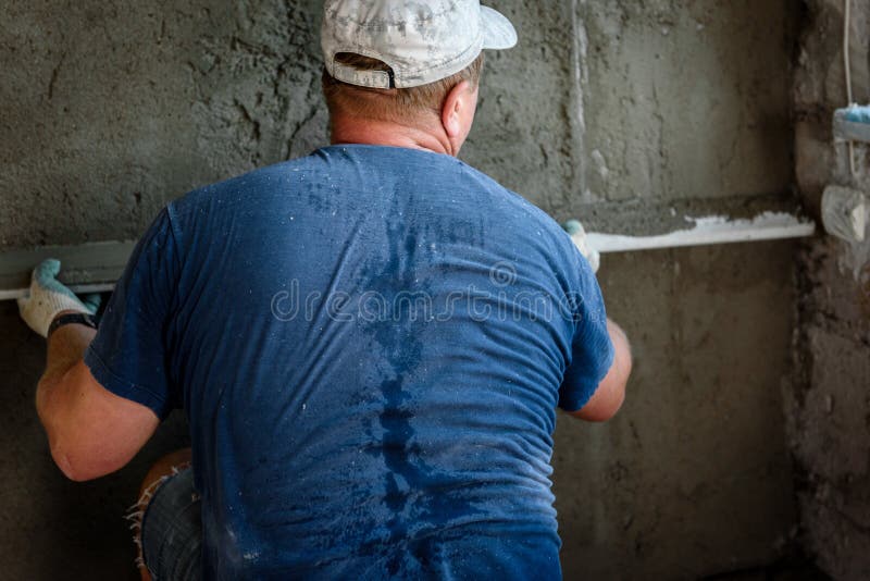 Construction Worker Plastering Wall with Leveler Stock Photo - Image of ...
