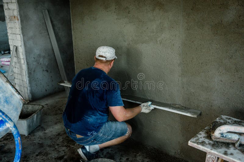 Construction Worker Plastering Wall with Leveler Stock Image - Image of ...