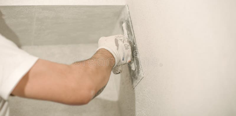 A Worker is Plastering the Electric Cables in the Wall. Stock Photo ...
