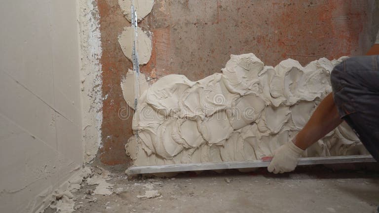 Construction Worker Plastering a Wall Using a H-rule. Construction ...