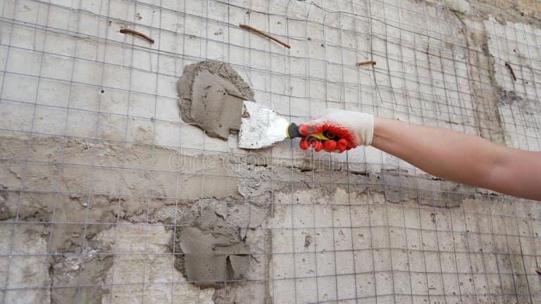 Construction Worker Applying Plaster on Wall with Trowel Over Metal ...