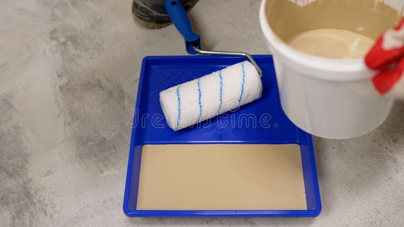 Construction Worker Pouring Primer into Paint Tray for Floor Priming ...