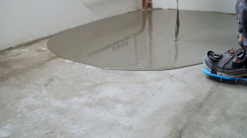 Construction Worker Pouring Self-leveling Concrete Mix on the Floor ...