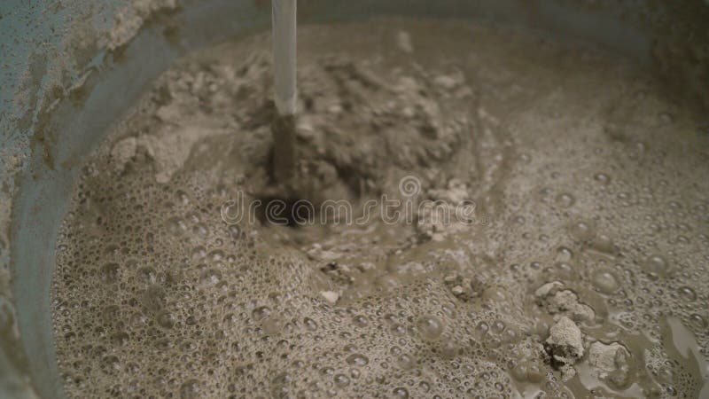 Construction Worker Pouring Water into Cement Mix for Building Project ...