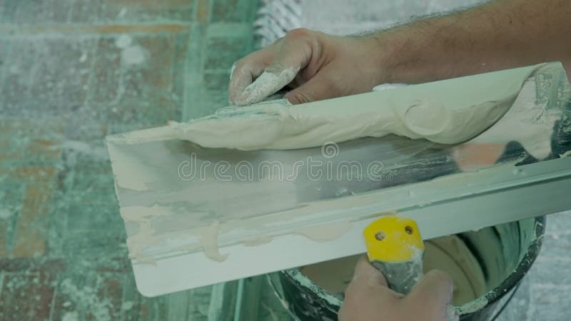 Worker Preparing Putty for Wall Application with Trowel Stock Photo ...