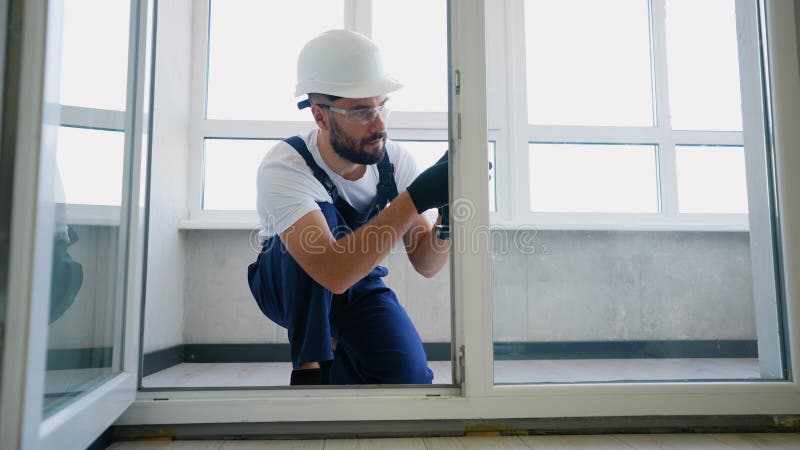 Worker Installing Window Frame Using Power Drill for Secure Fit Stock ...