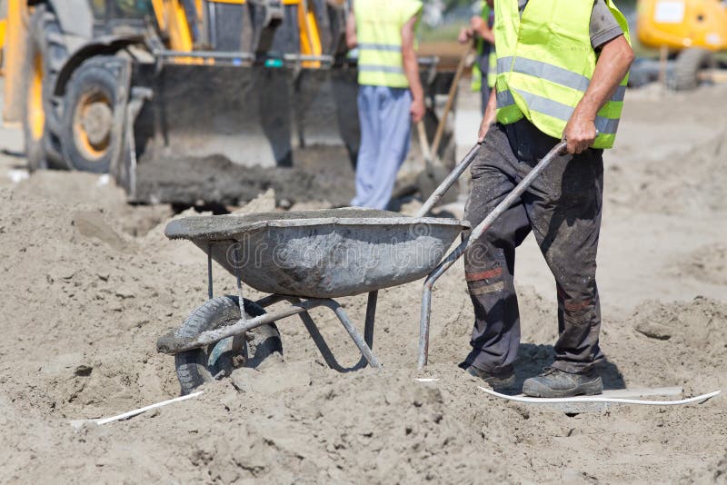 Construction Worker Pushing Wheelbarrow Stock Image - Image of liquid ...