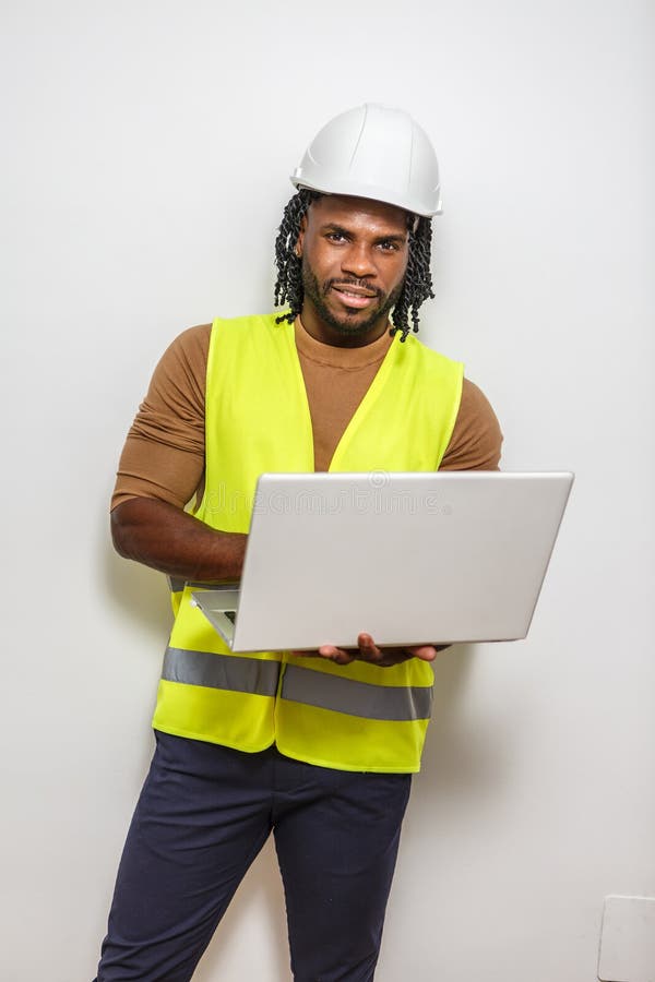Construction Worker in Reflective Vest Using a Laptop Computer in Front ...