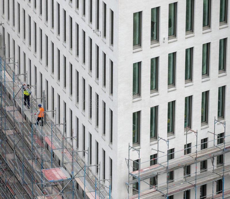 Construction Worker Remove Scaffolding of a New Building. Stock Image ...