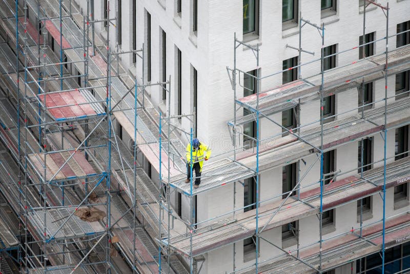 Construction Worker Remove Scaffolding of a New Building. Editorial ...