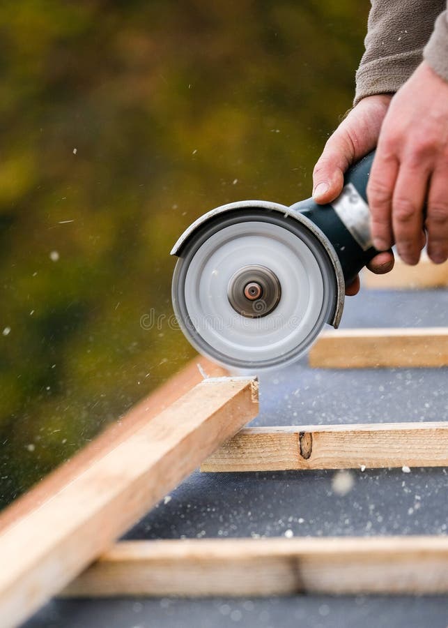 Construction Worker Cutting with a Disc-maker a Wood Cleat for the ...