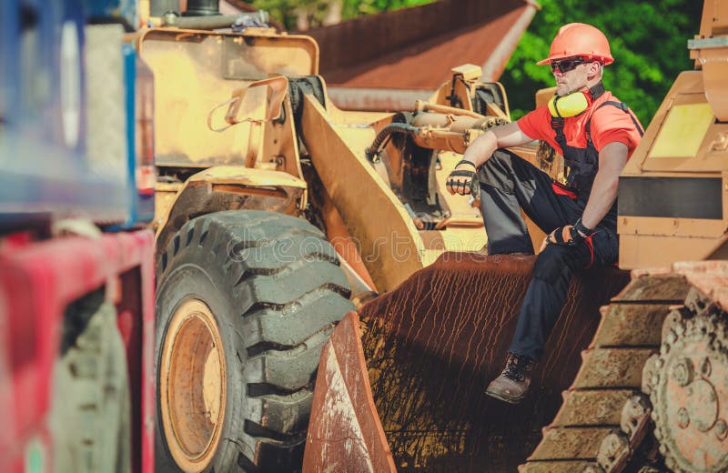 Construction Worker Resting on Heavy Machinery during Work Hours Stock ...