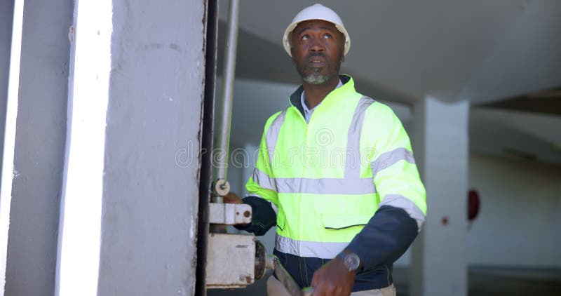 Construction Worker, Roller and Man at Garage Door of Factory with ...