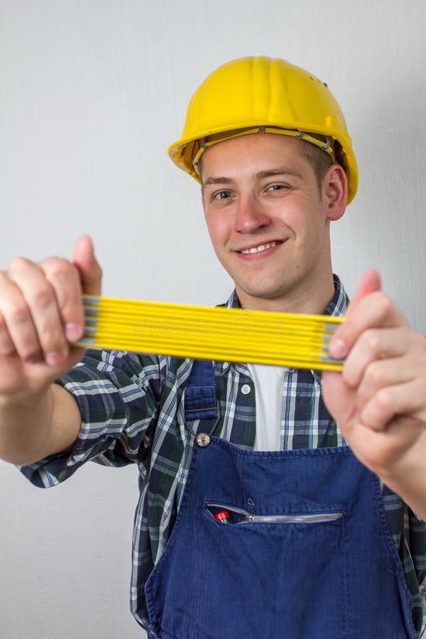 Construction Worker with a Ruler Stock Photo - Image of hand, plain ...