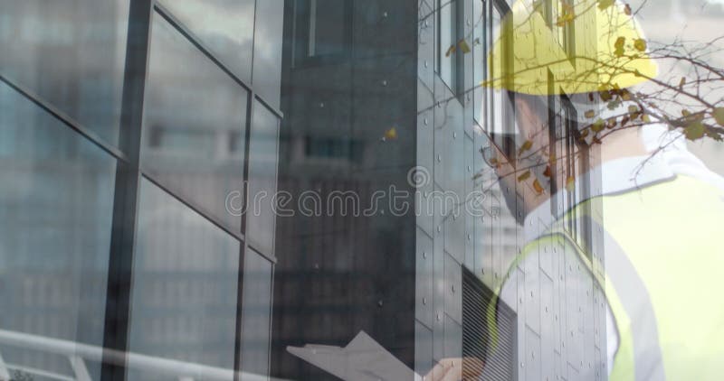 Construction Worker in Safety Vest and Helmet Inspecting Building with ...