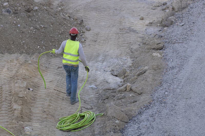 Construction Worker in the Sand Stock Photo - Image of carry, worker ...