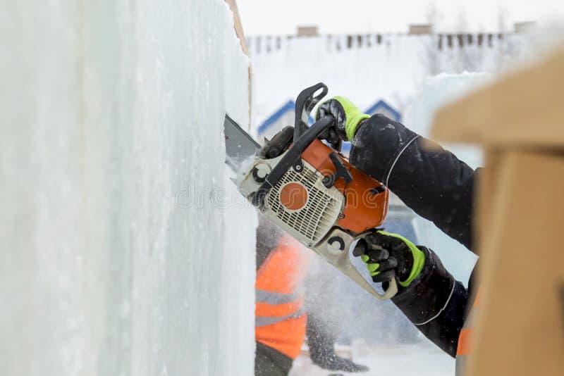 Worker Cuts a Lump of Ice with a Chainsaw Stock Photo - Image of ...