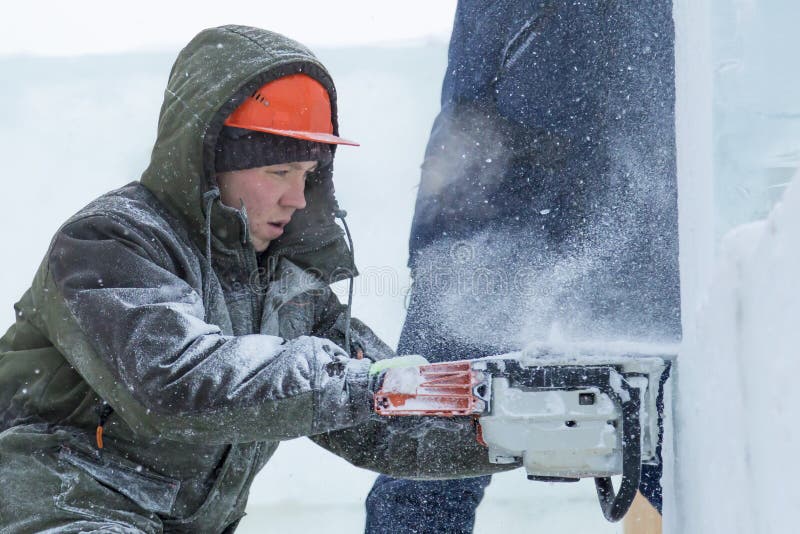 Worker Cuts a Lump of Ice with a Chainsaw Stock Photo - Image of ...