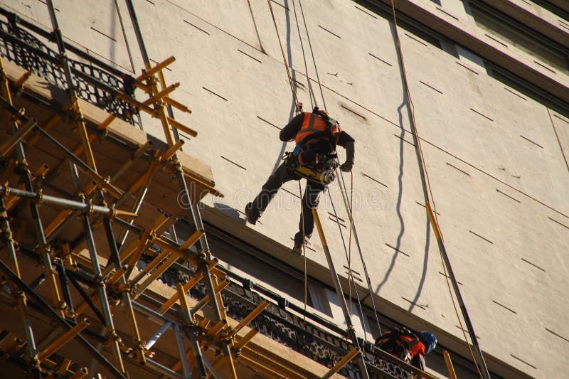 Construction Worker on a Scaffold Working on a Building S Side Stock ...