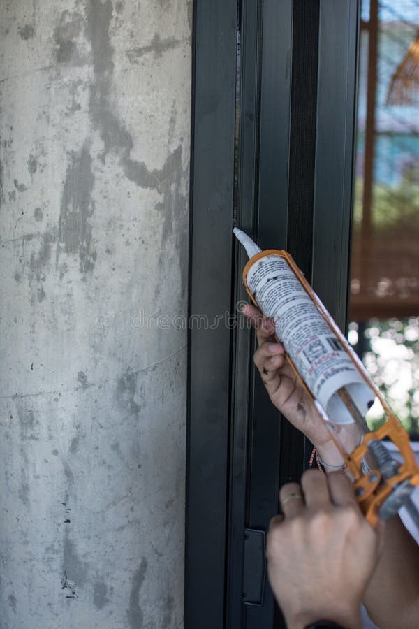 Construction Worker Sealing Window with Caulk Indoors Stock Photo ...