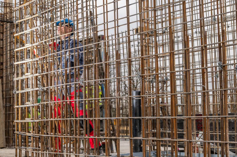 Construction Worker Engaged in Rebar Installation at Building Site ...