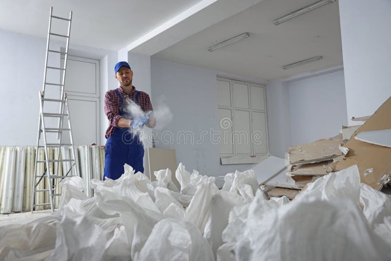 Construction Worker Shaking Off Dust from Hands in Room Prepared for ...