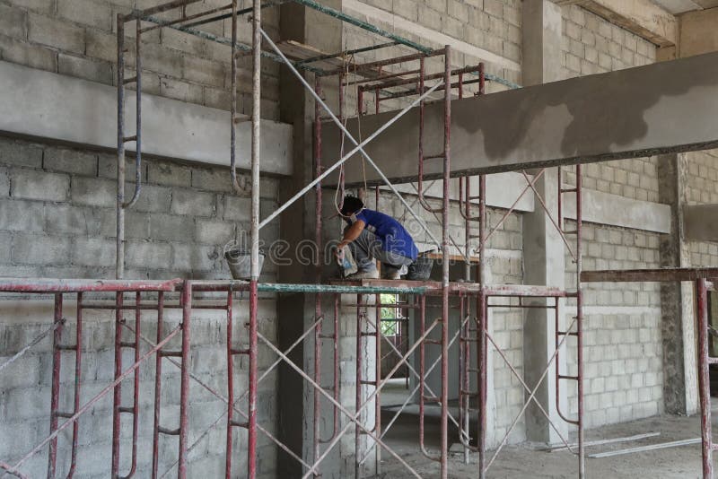 Construction Worker Sit on Scaffolding and Plastering Building Wall and ...