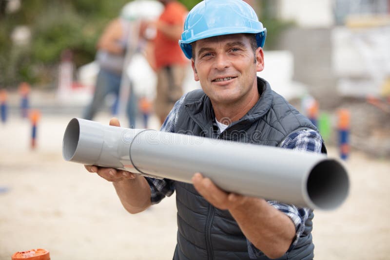 Construction Worker on Site Holding Pipe Stock Image - Image of builder ...