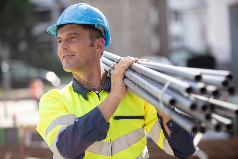 Construction Worker on Site Holding Pipe Stock Photo - Image of worker ...
