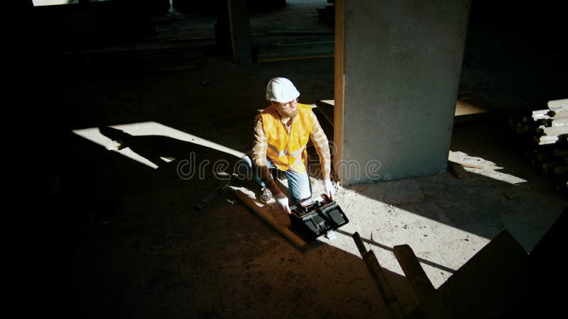 Construction Worker Sits Near the Wall and Open Toolbox at Construction ...
