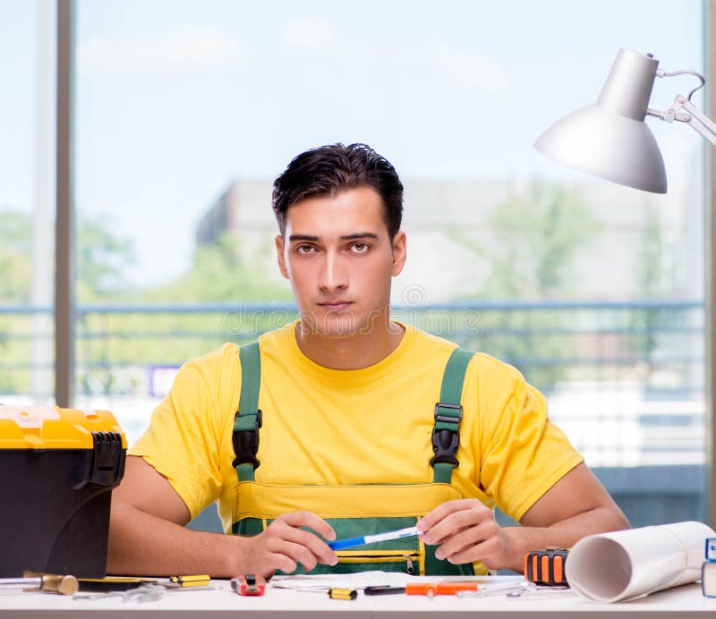 Construction Worker Sitting at the Desk Stock Photo - Image of builder ...