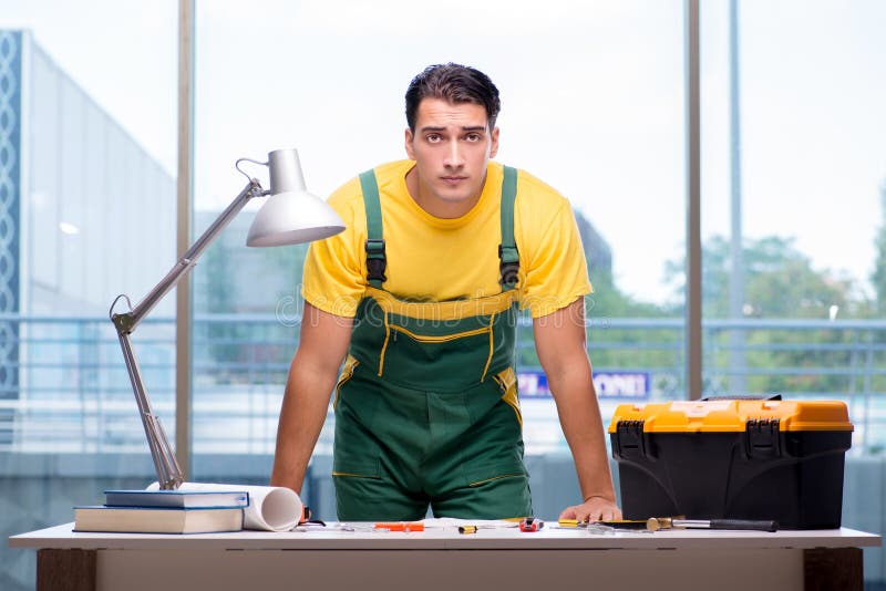 The Construction Worker Sitting at the Desk Stock Image - Image of ...