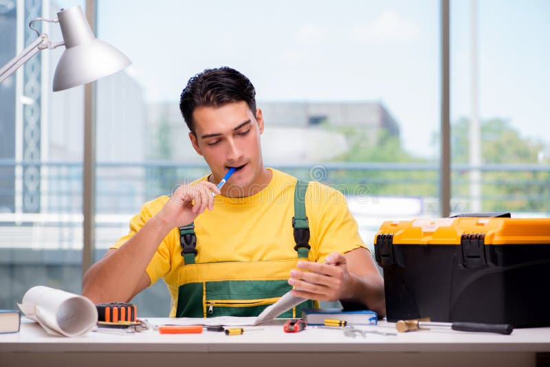 The Construction Worker Sitting at the Desk Stock Image - Image of ...