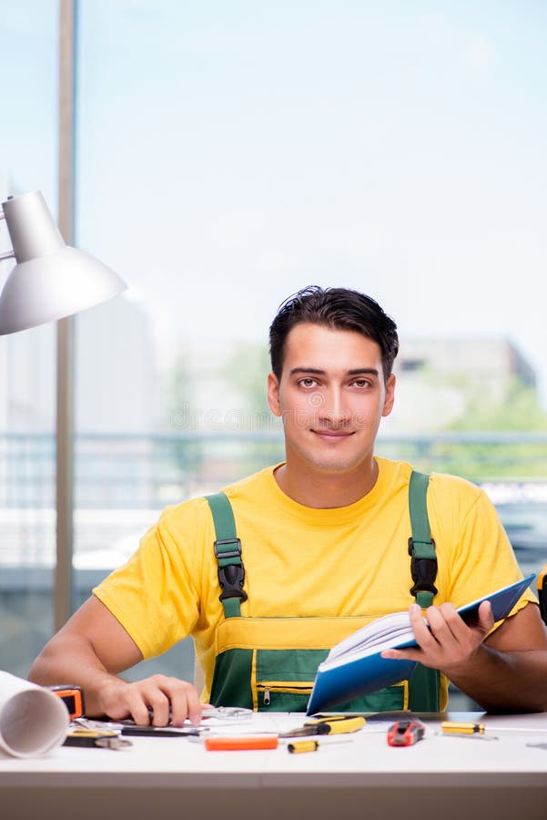 The Construction Worker Sitting at the Desk Stock Image - Image of ...